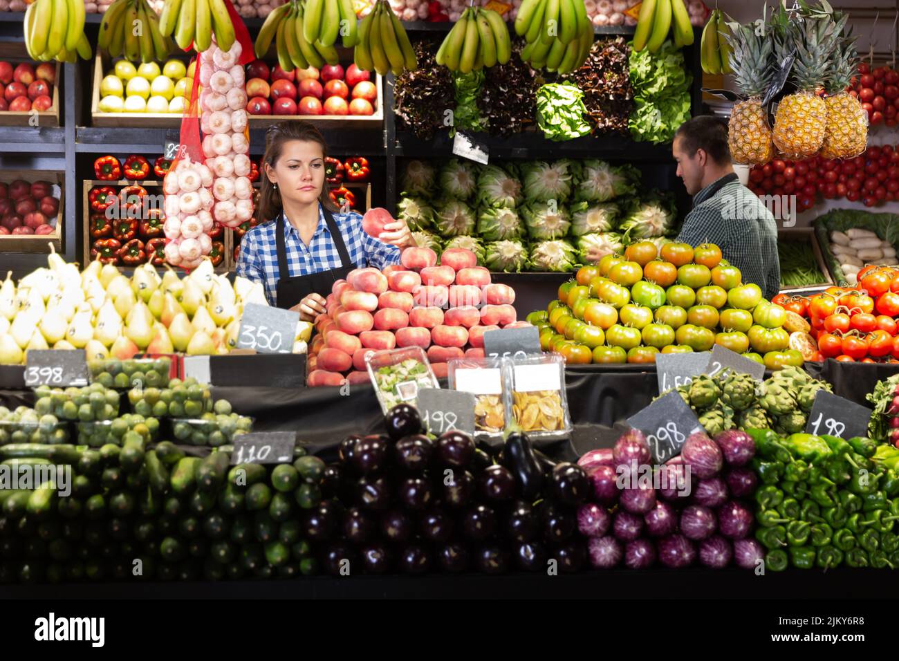 Two sellers laying out vegetables Stock Photo - Alamy