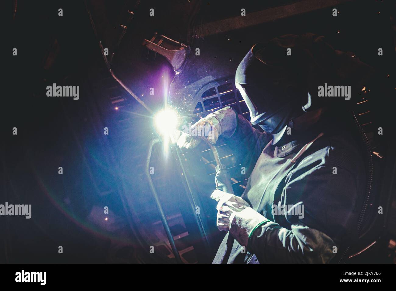 Professional welder working in dark hi-res stock photography and images ...