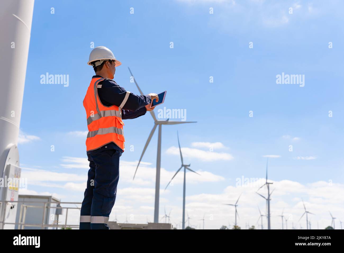 Engineer walk to check wind power plants with check performance. Wind ...