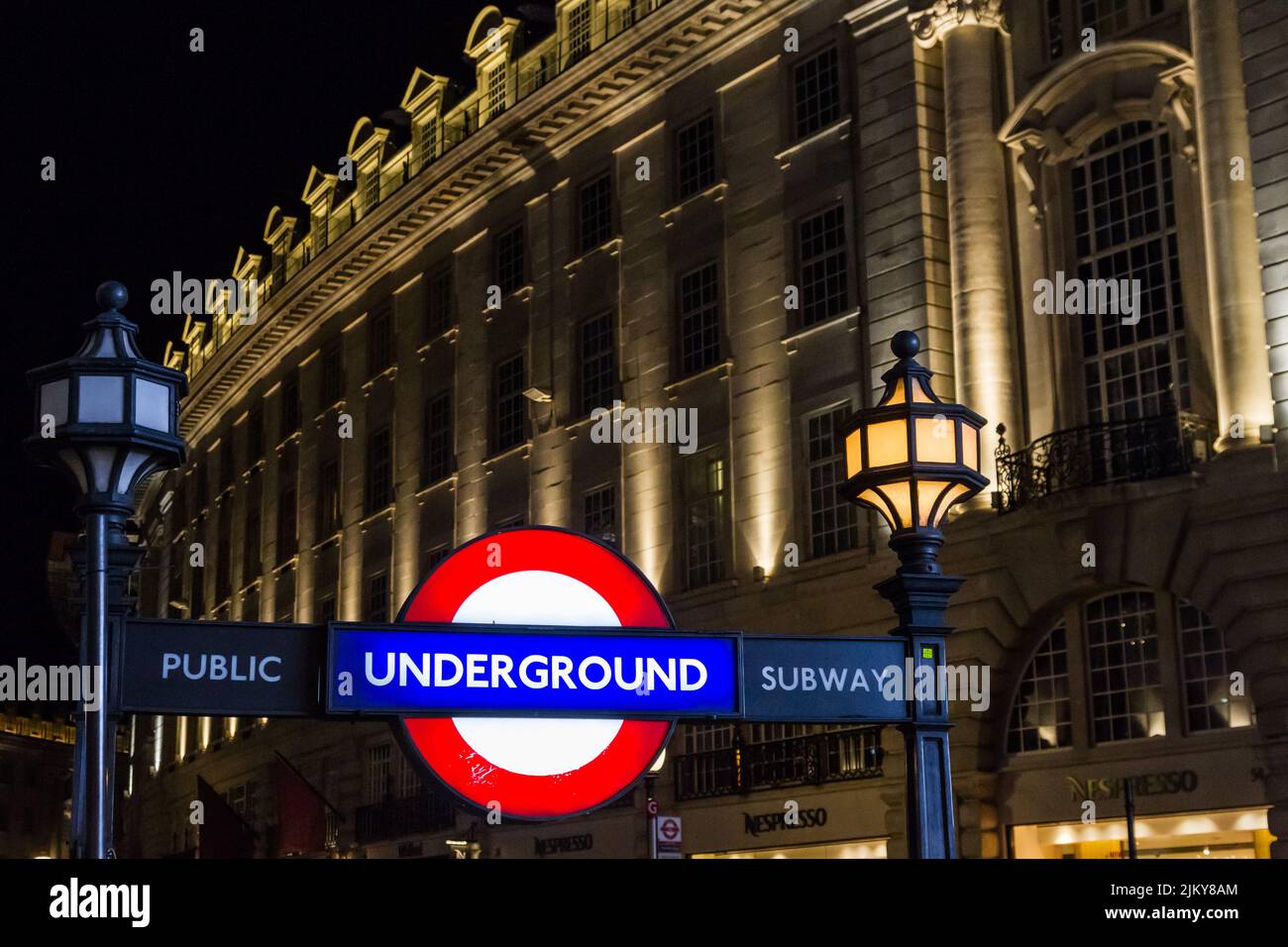 An underground sign in front of a beautiful building in London Stock ...