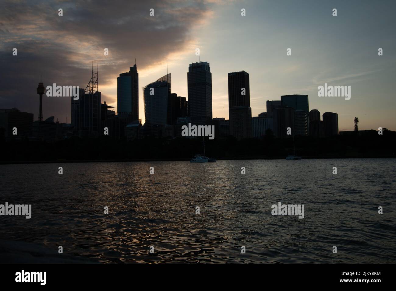 A low angle shot of modern buildings near water during the sunset Stock ...