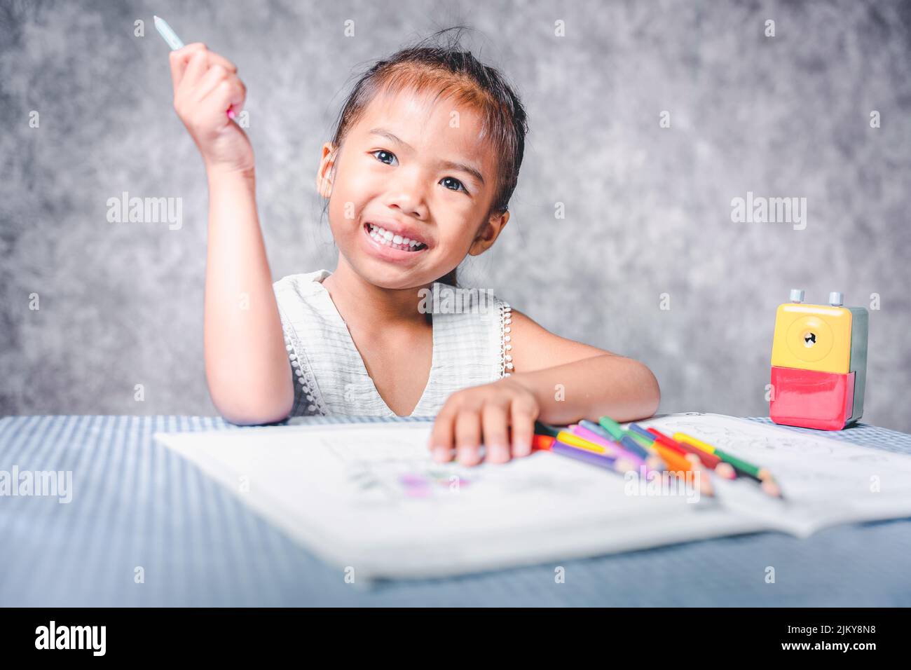 School girl colouring in picture hi-res stock photography and images ...