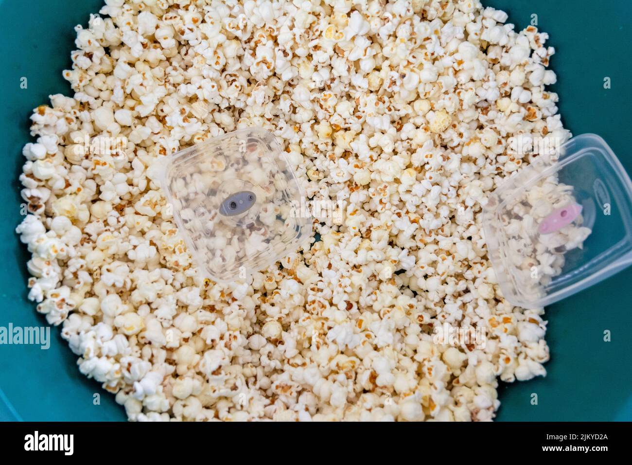 White salted popcorn inside a green plastic container. Salvador, Bahia ...