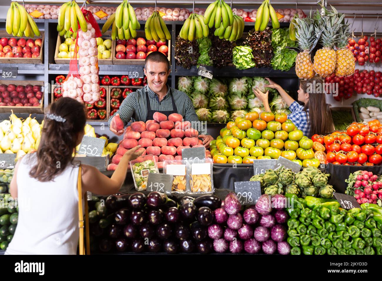 Friendly shop assistans selling fruits Stock Photo - Alamy