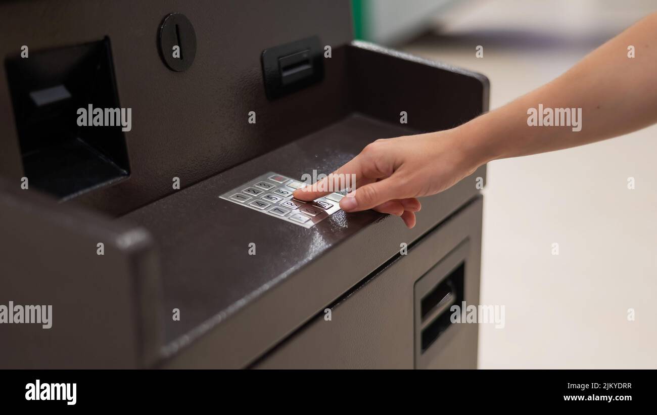 Faceless woman dialing bank card pin at ATM Stock Photo - Alamy