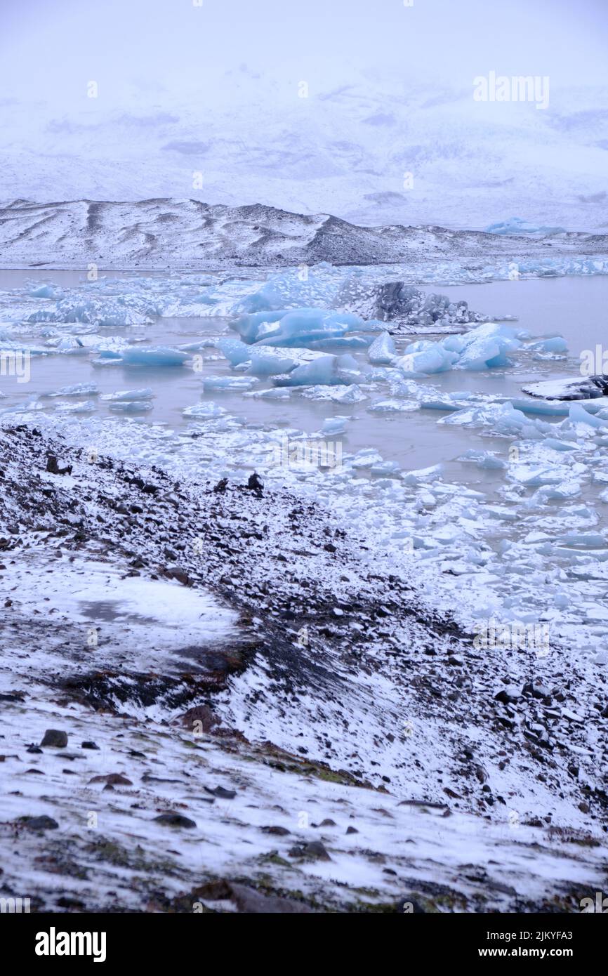 Vertical view of icebergs on Fjallsarlon Glacier Lake in Iceland ...