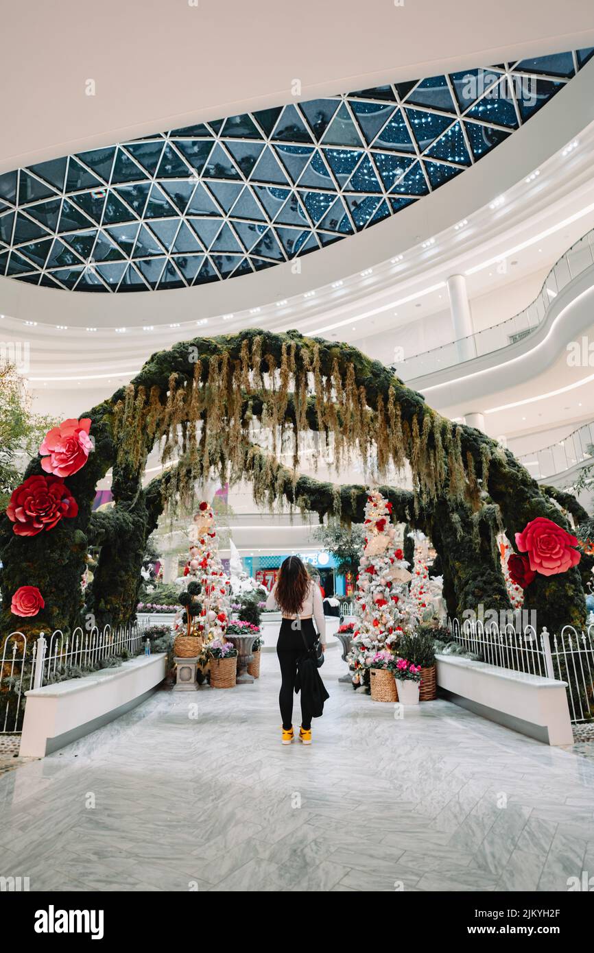 A female standing under the decorative arch inside the building Stock ...