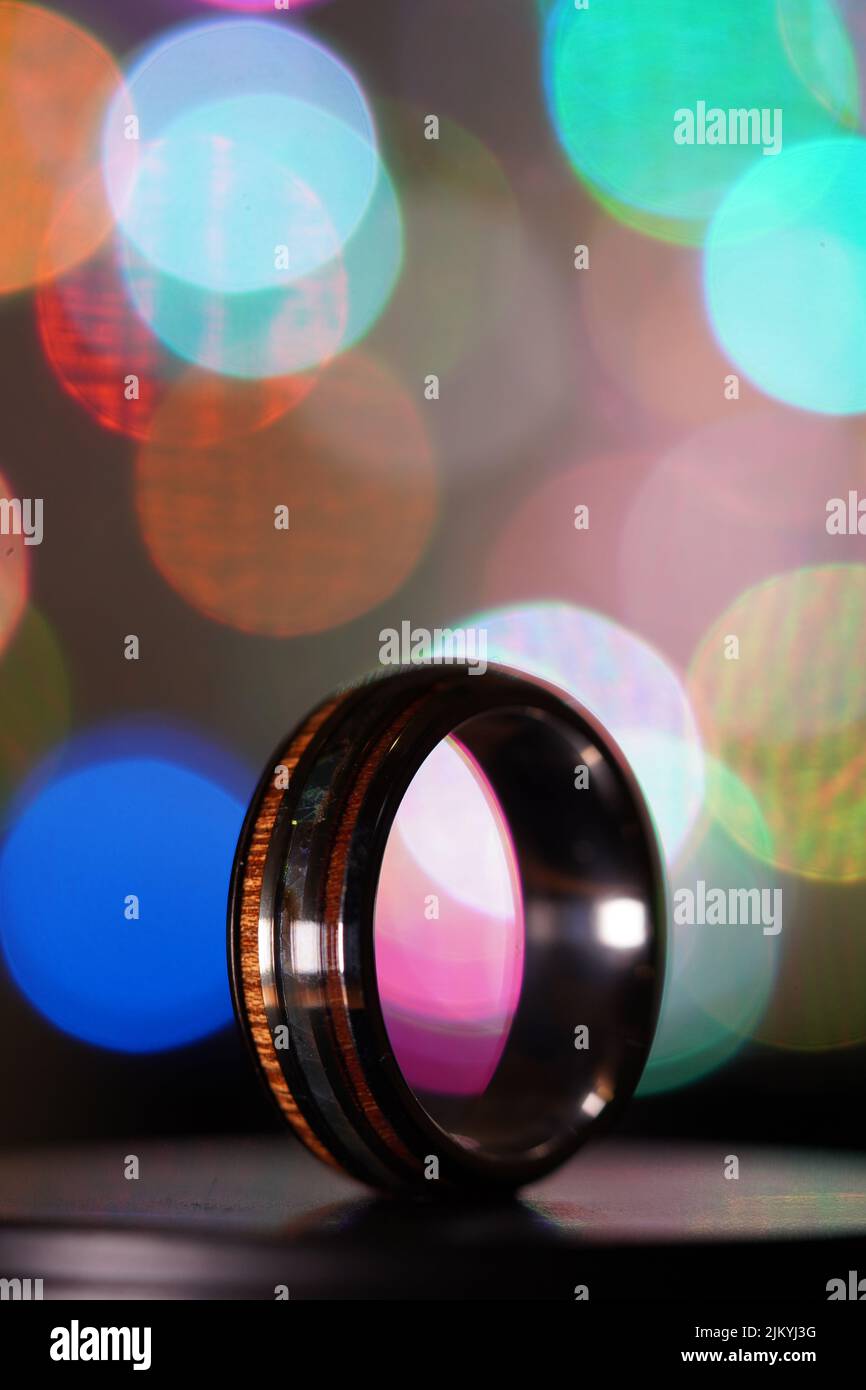 A vertical shot of a brown camera lens isolated in colorful glare ...