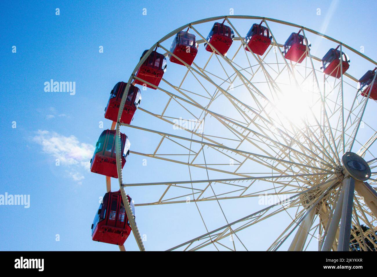 Sun shines through a ferris wheel Stock Photo - Alamy