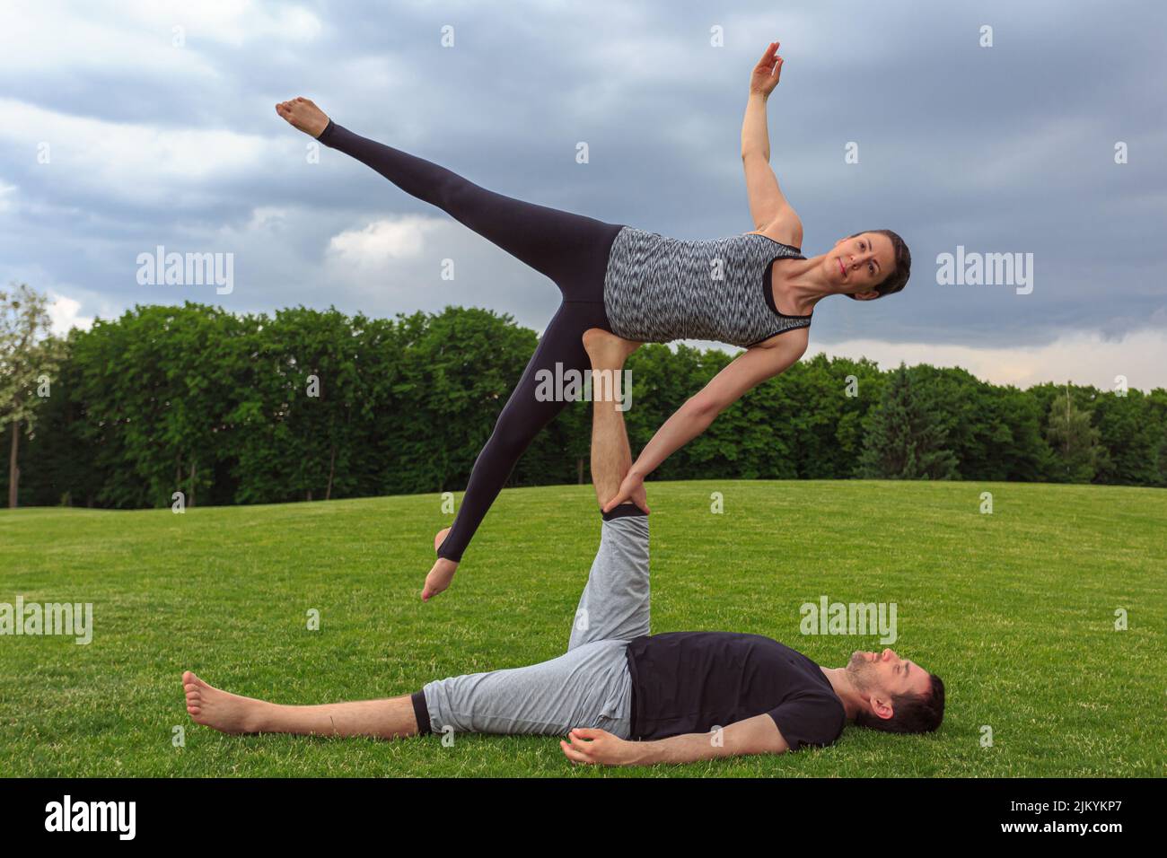 Strong acrobatic woman lifting man hi-res stock photography and images ...