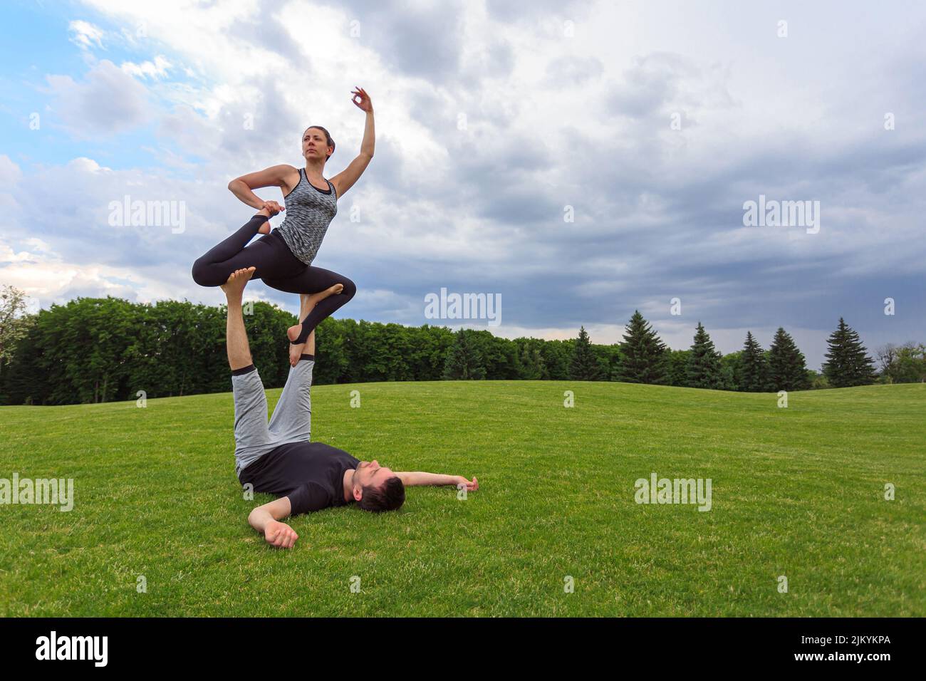 Strong acrobatic woman lifting man hi-res stock photography and images ...