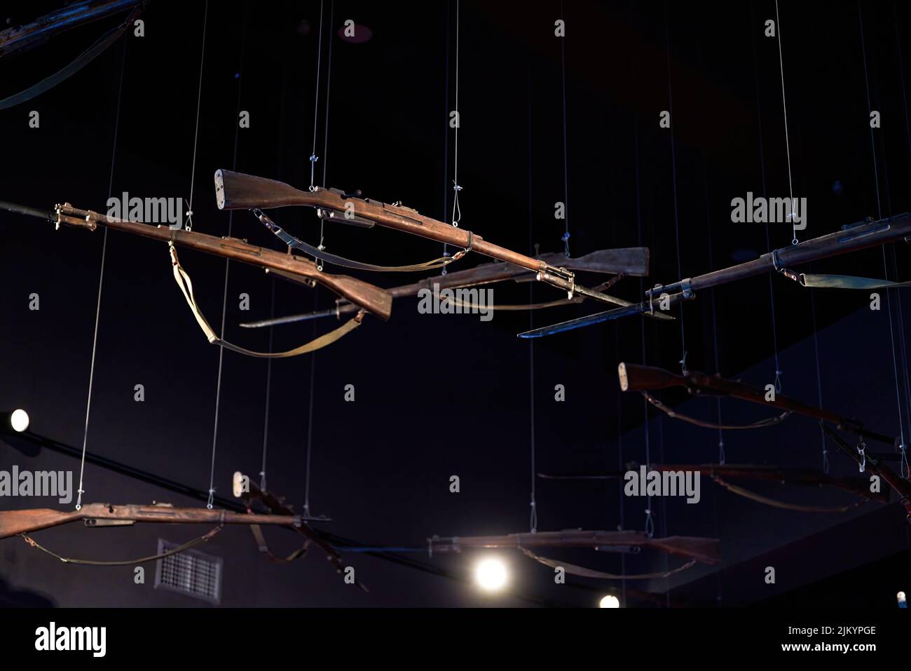 Vintage assault rifle hanging from the ceiling Stock Photo - Alamy