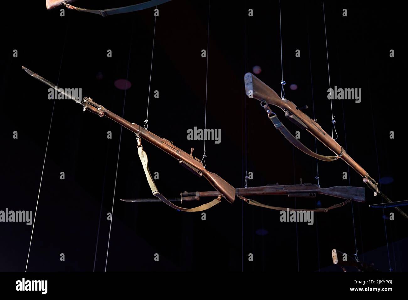 Vintage assault rifle hanging from the ceiling Stock Photo - Alamy