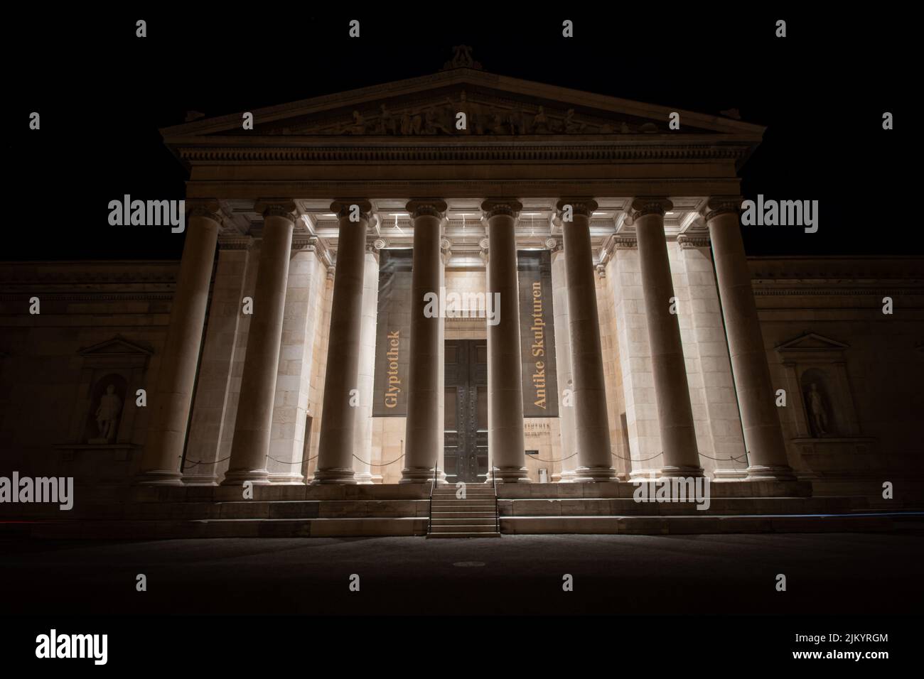 A low angle shot of old Pinakothek at the night with black sky in the ...