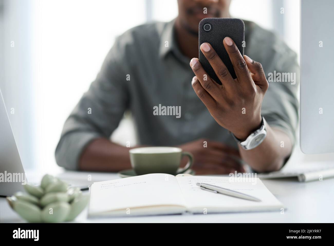 Quick video call. a young man using his phone at work Stock Photo - Alamy