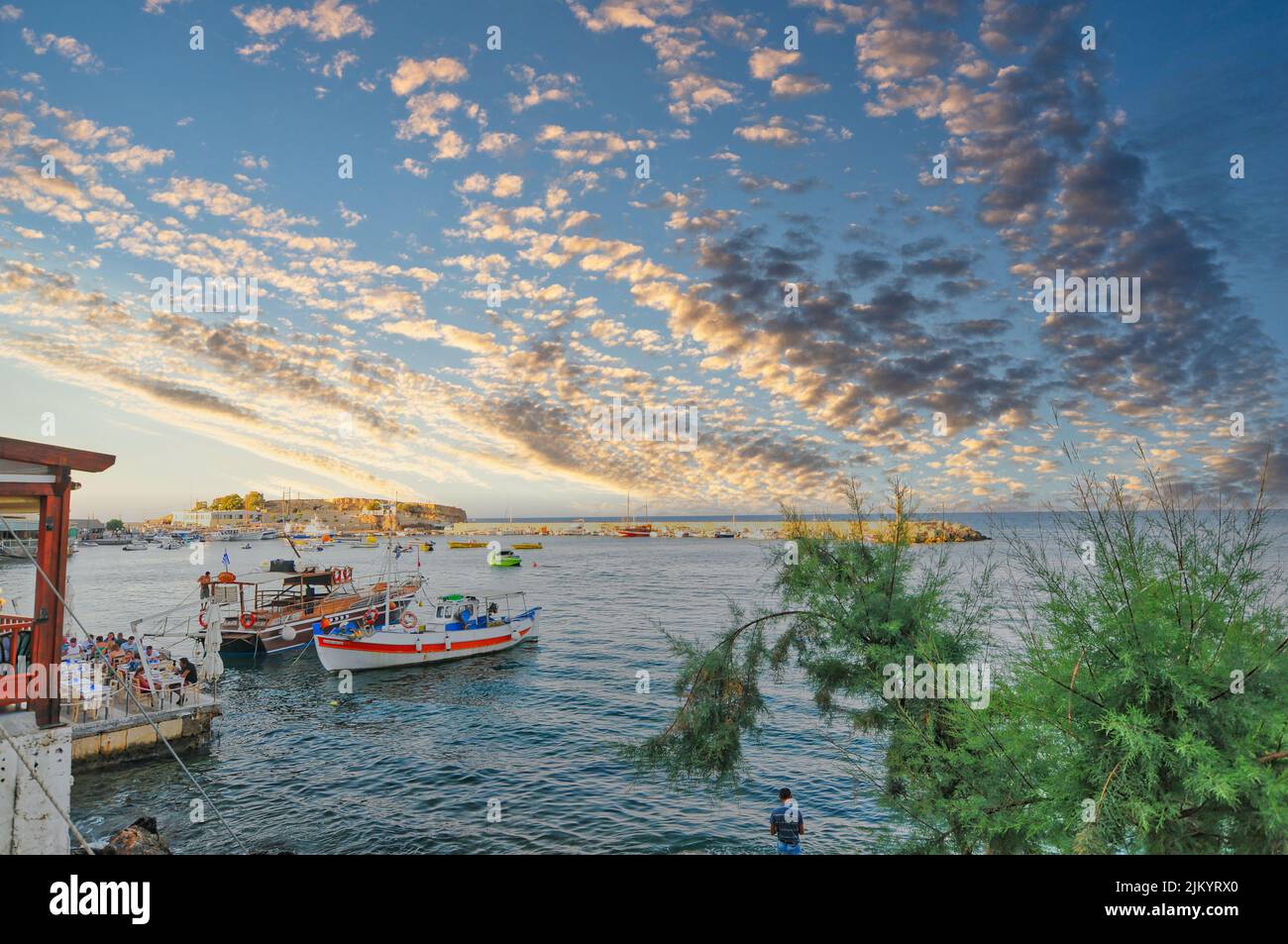 Boats and ships moored in the harbour with views towards the town ...