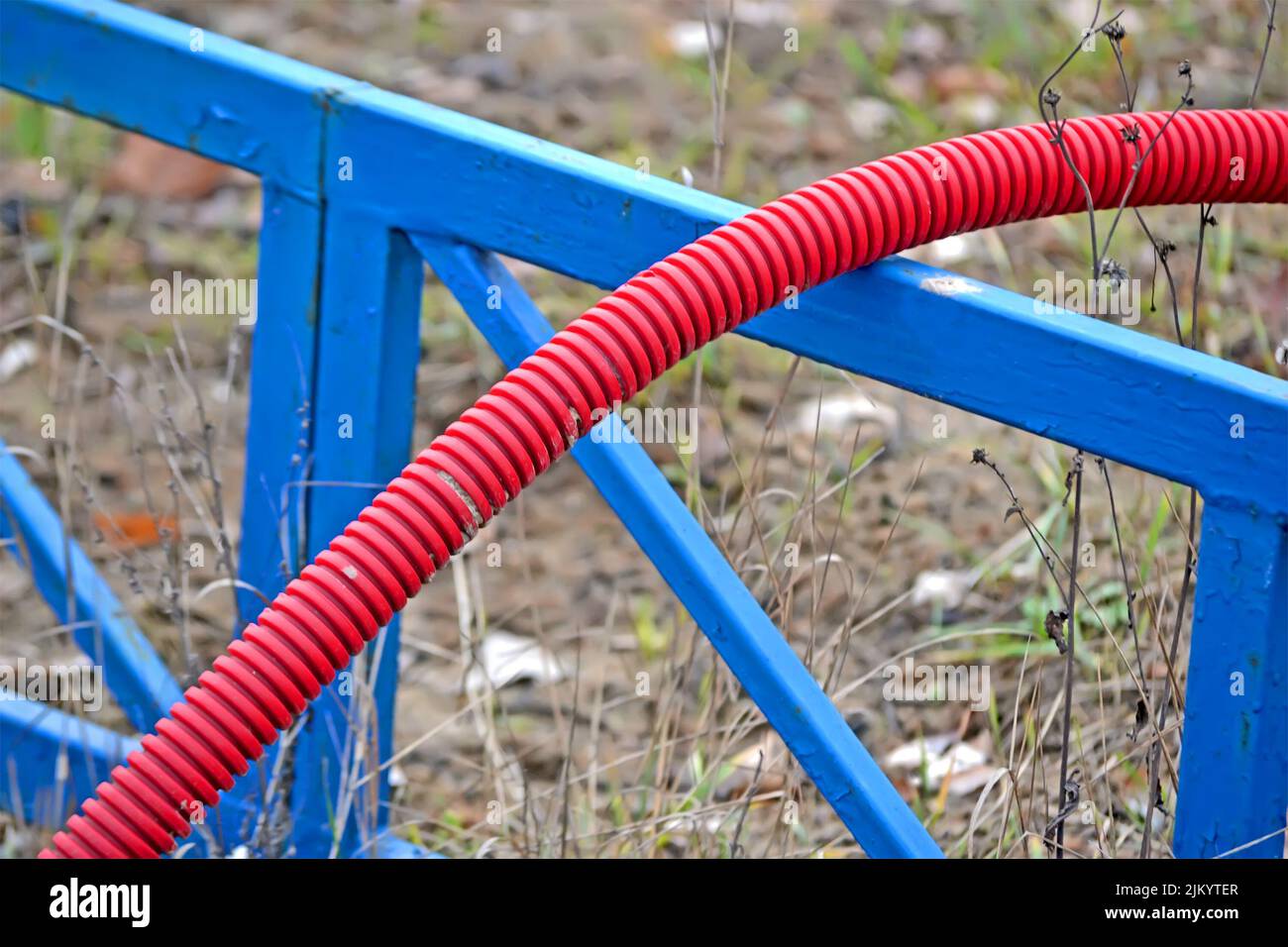 red plastic pipe garbage on blue construction closeup, environment ...
