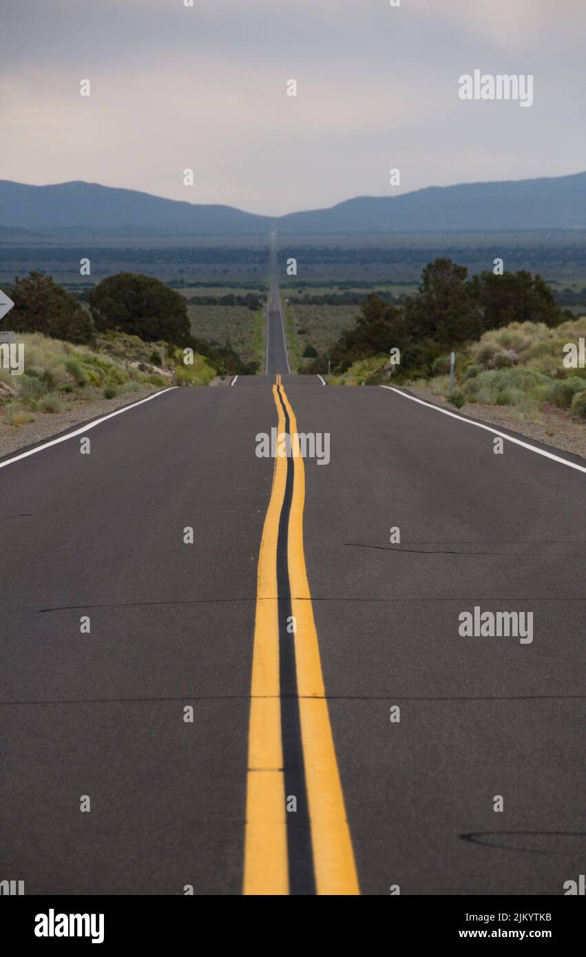 A closeup of an empty highway in the middle of farm field in California ...