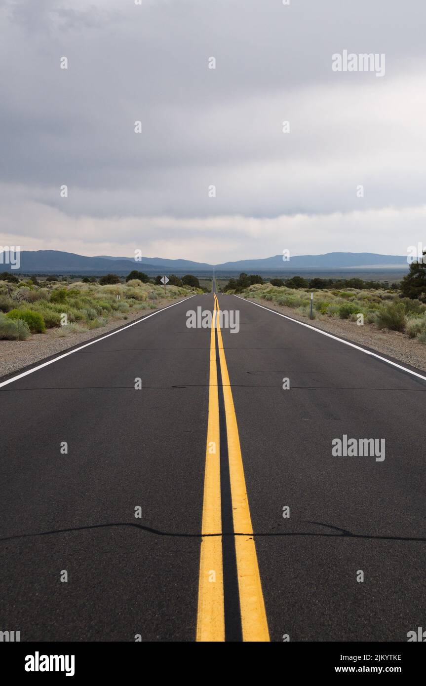 An empty highway in between green rural fields Stock Photo - Alamy