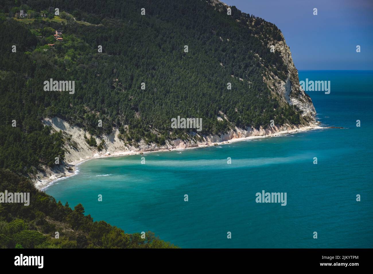 A beautiful landscape scene of green mountains by the tranquil blue ...