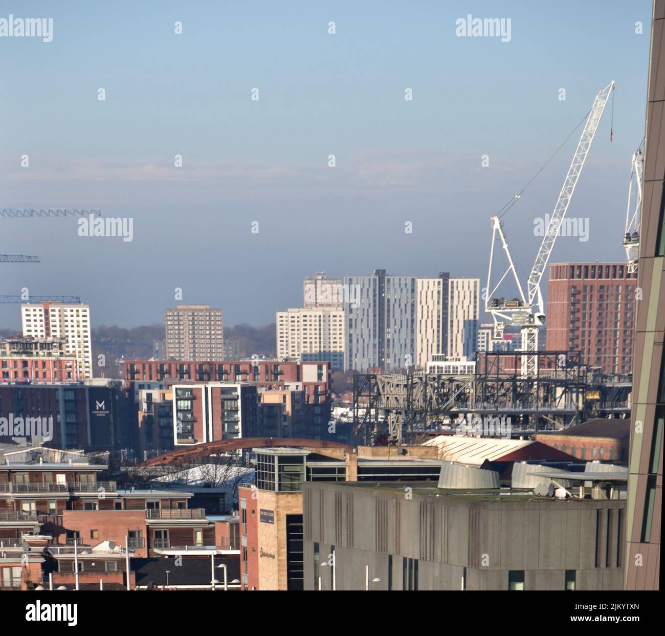 A scenery of urban buildings and new constructions with cranes in ...