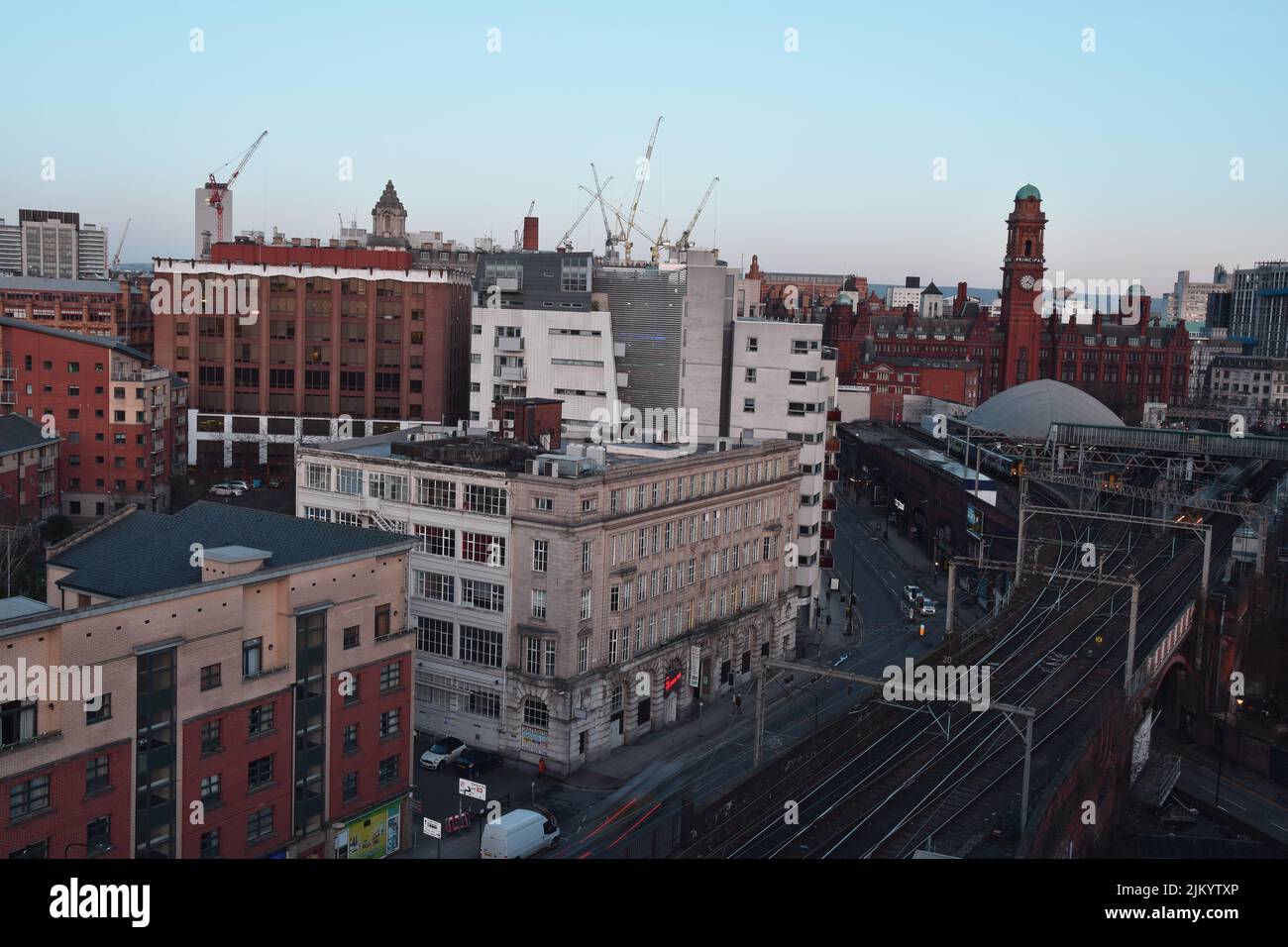 A scenery of urban buildings and new constructions with cranes in ...