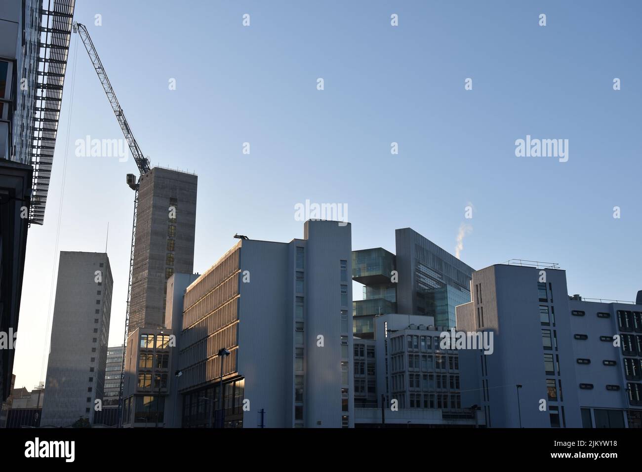A scenery of urban buildings and new constructions with cranes in ...