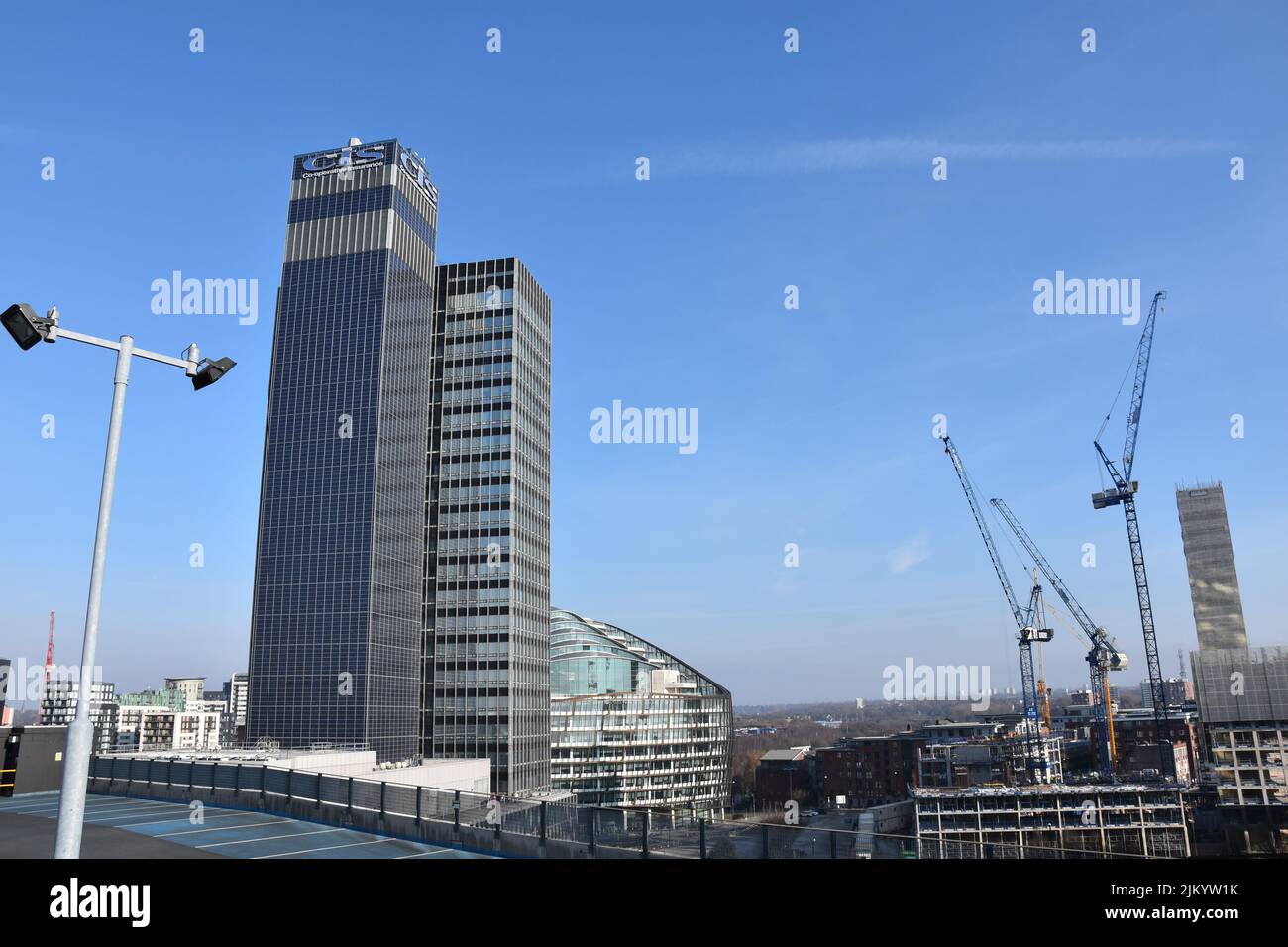 A scenery of urban buildings and new constructions with cranes in ...