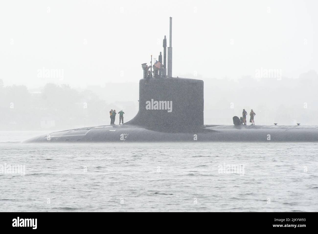 USS Oregon (SSN 793) makes its way down the Thames River and past the ...