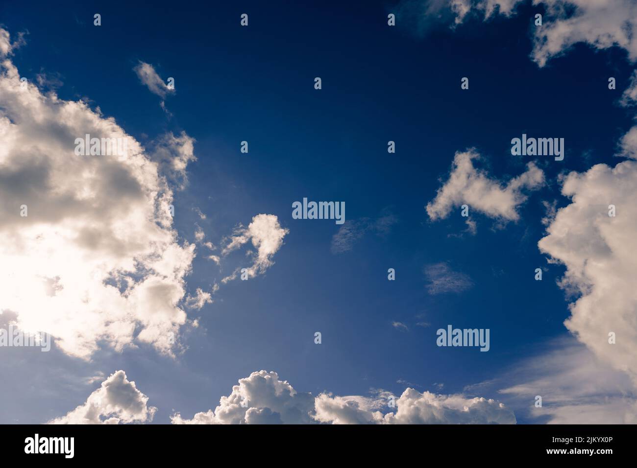 Blue sky with clouds and sun shines bright in the daytime in summer ...