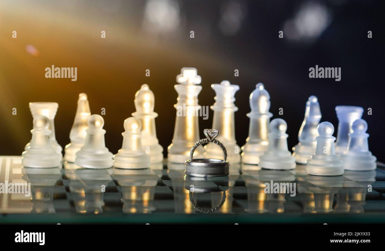A close-up of rings with chess pieces on background Stock Photo - Alamy