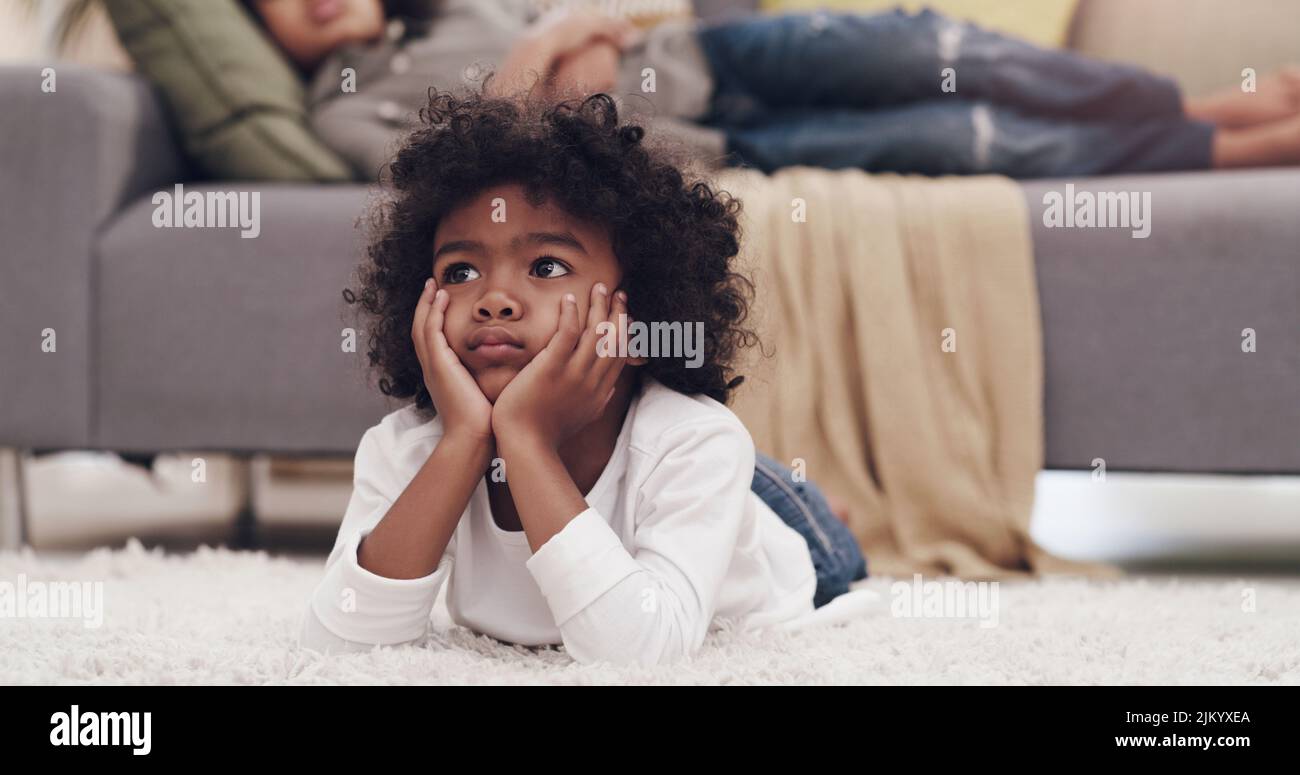 Can we watch something else. an adorable little boy lying down on a ...