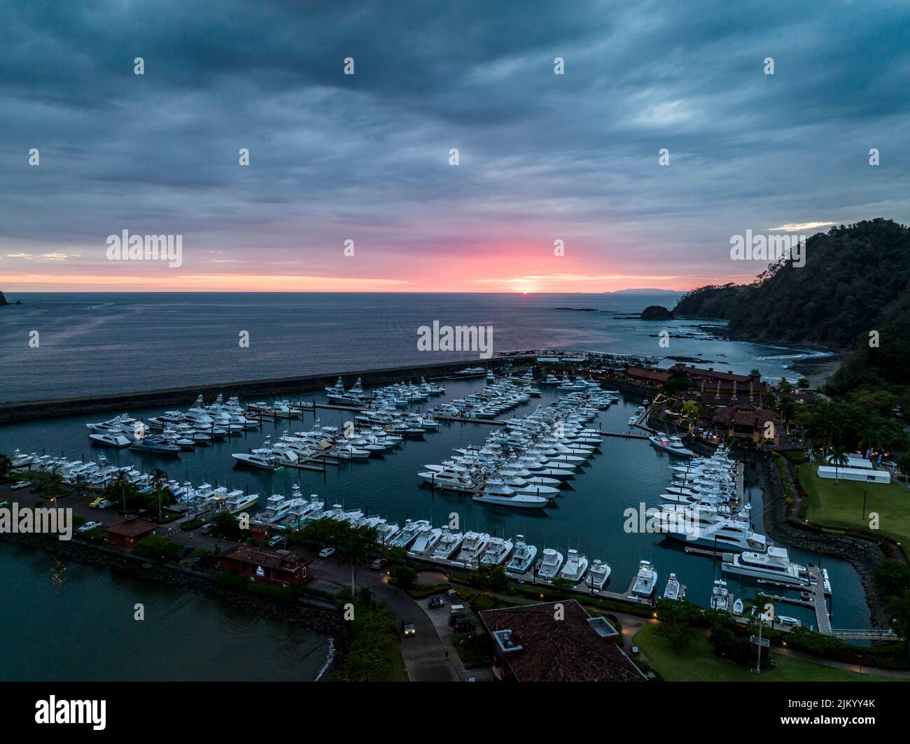 An aerial shot of a marina dock with boats on the ocean in Costa Rica ...