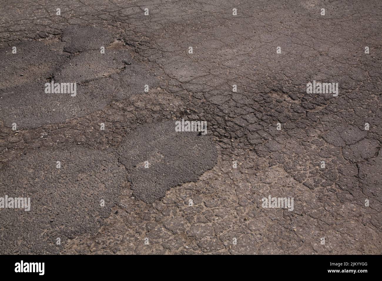 Close-up of cracked asphalt pavement Stock Photo - Alamy