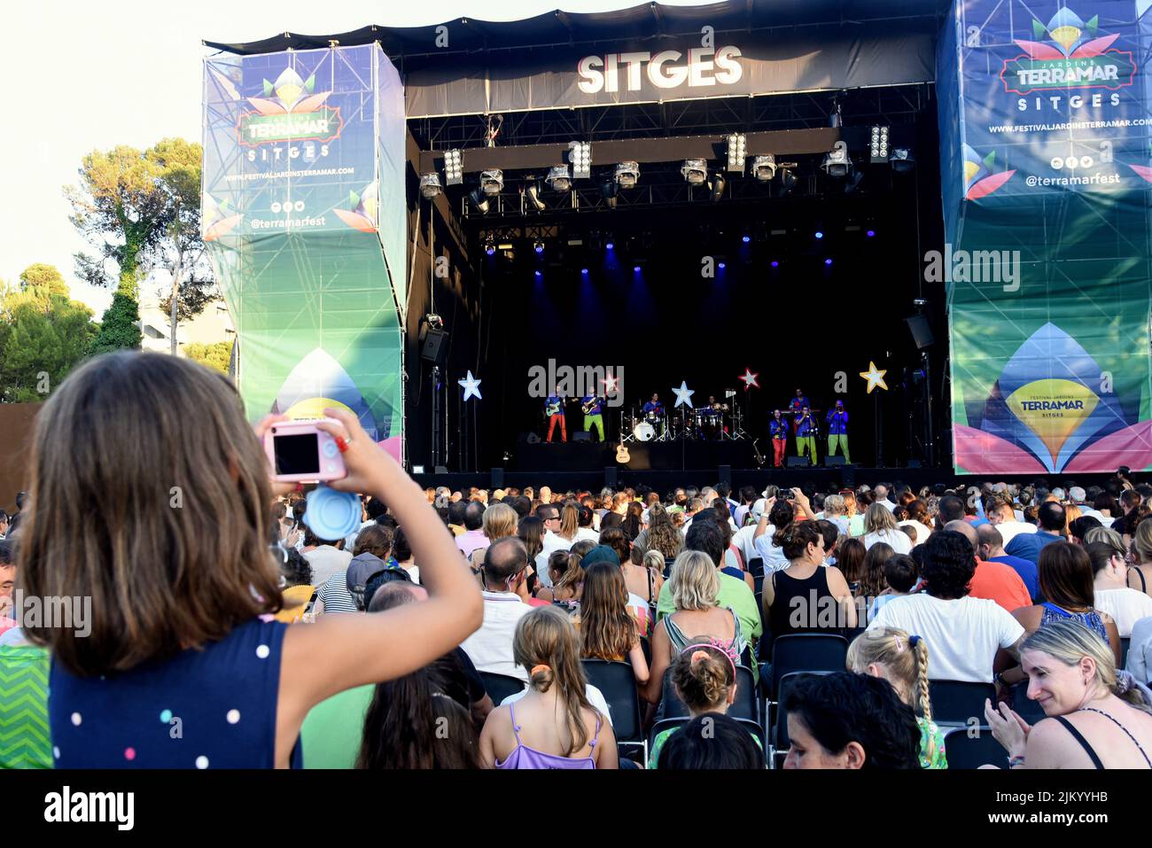 A girl photographs her group of which El Pot Petit is a fan during ...