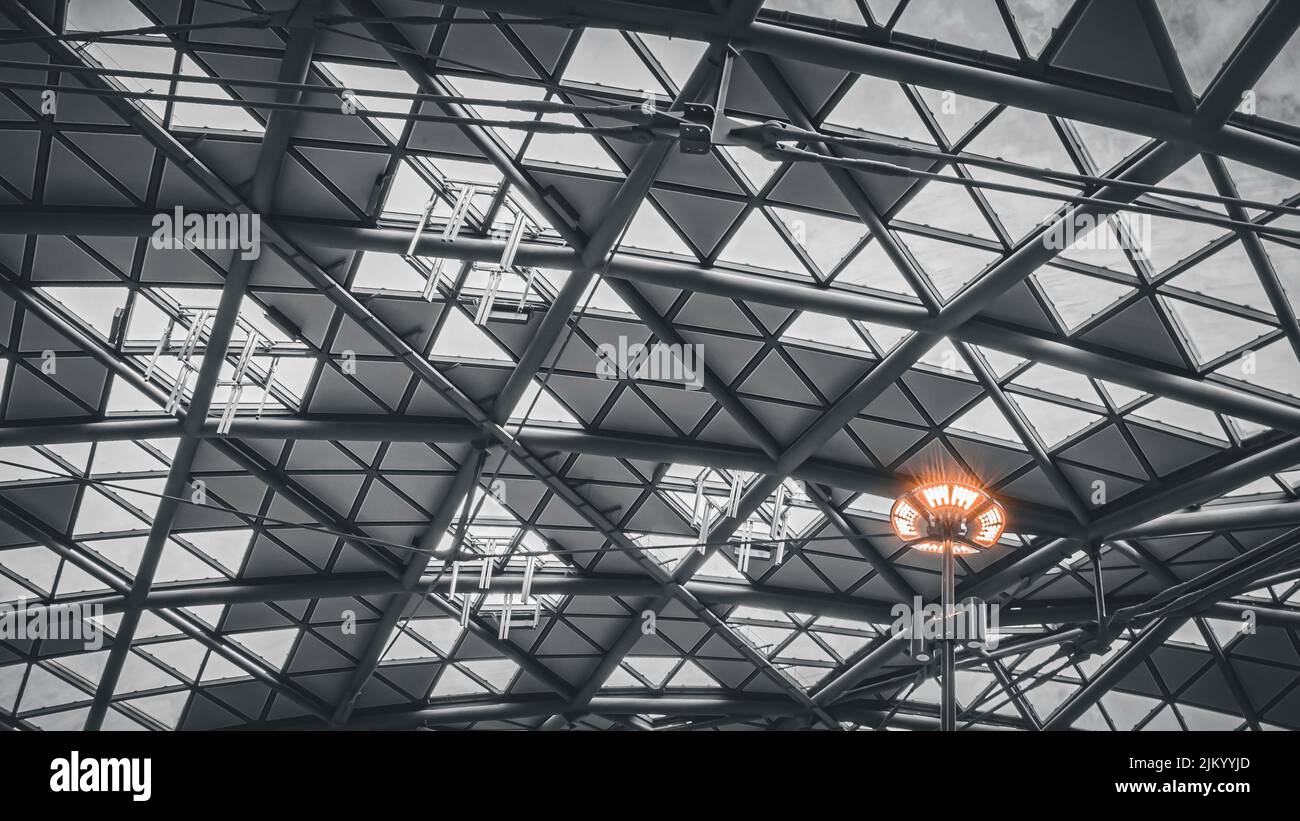 A low angle shot of a modern, symmetrical roof with triangular windows ...