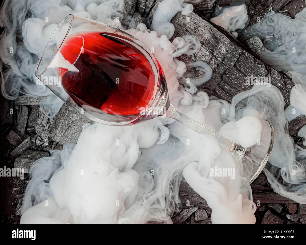 A top view of a glass of red wine on smoke and ashes of bonfire Stock ...