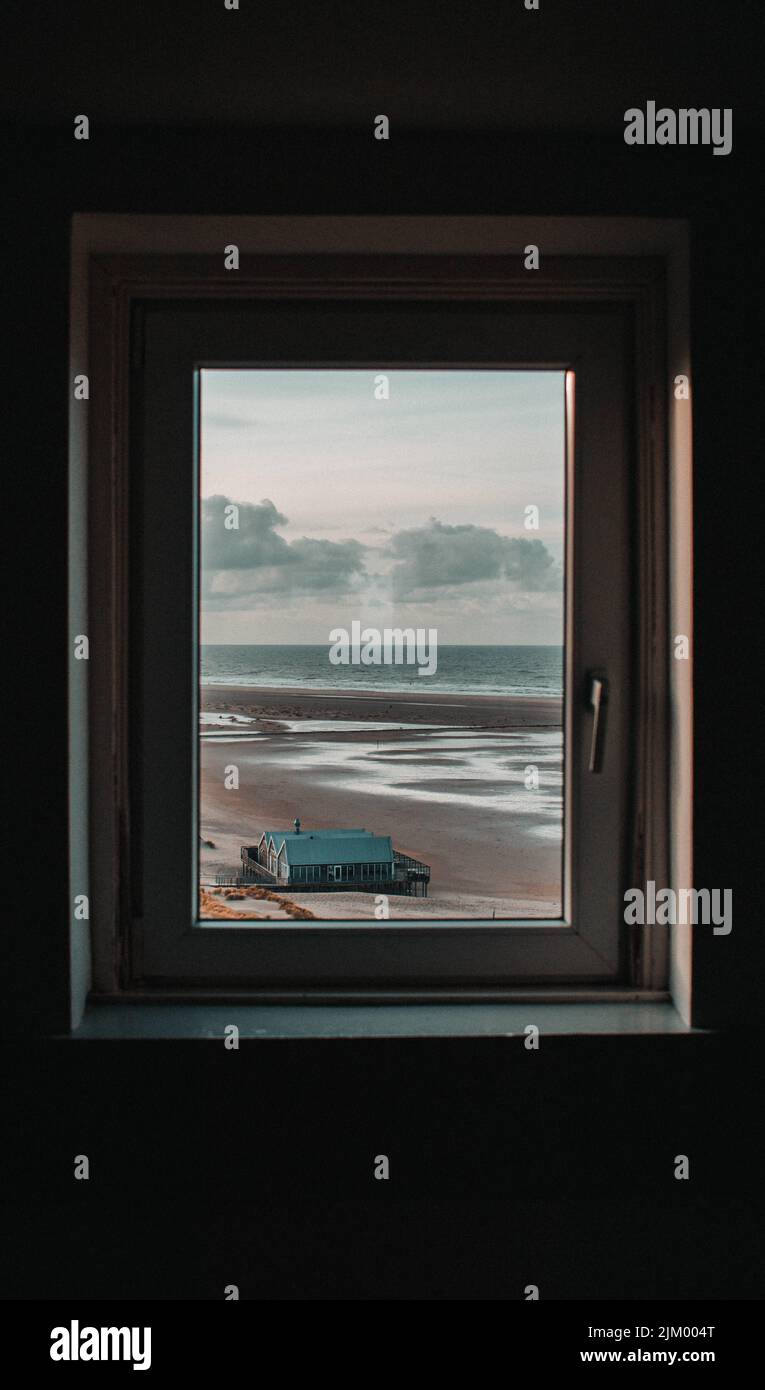 A vertical shot from a window of a beach scene on a rainy day Stock ...
