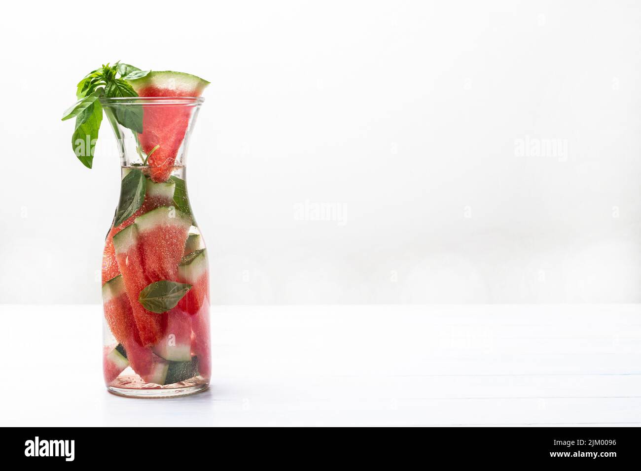 Sparkling watermelon water with green basil in glass jar. Copy space ...