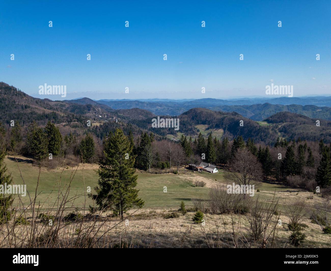 A building on the green landscape with trees in Slovenian Alps Stock ...