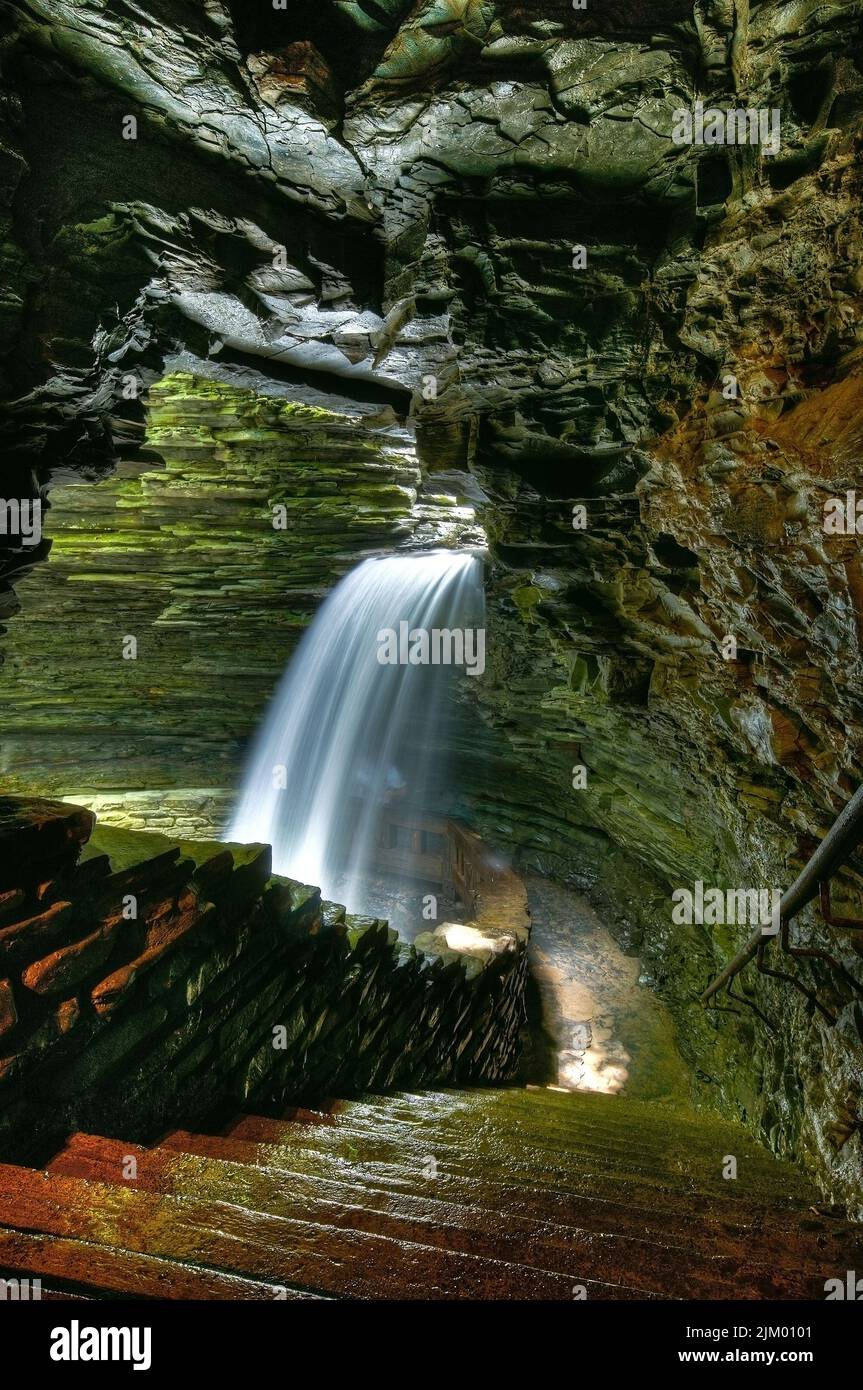 A breathtaking view of a waterfall inside a cave at Watkins Glen in New ...