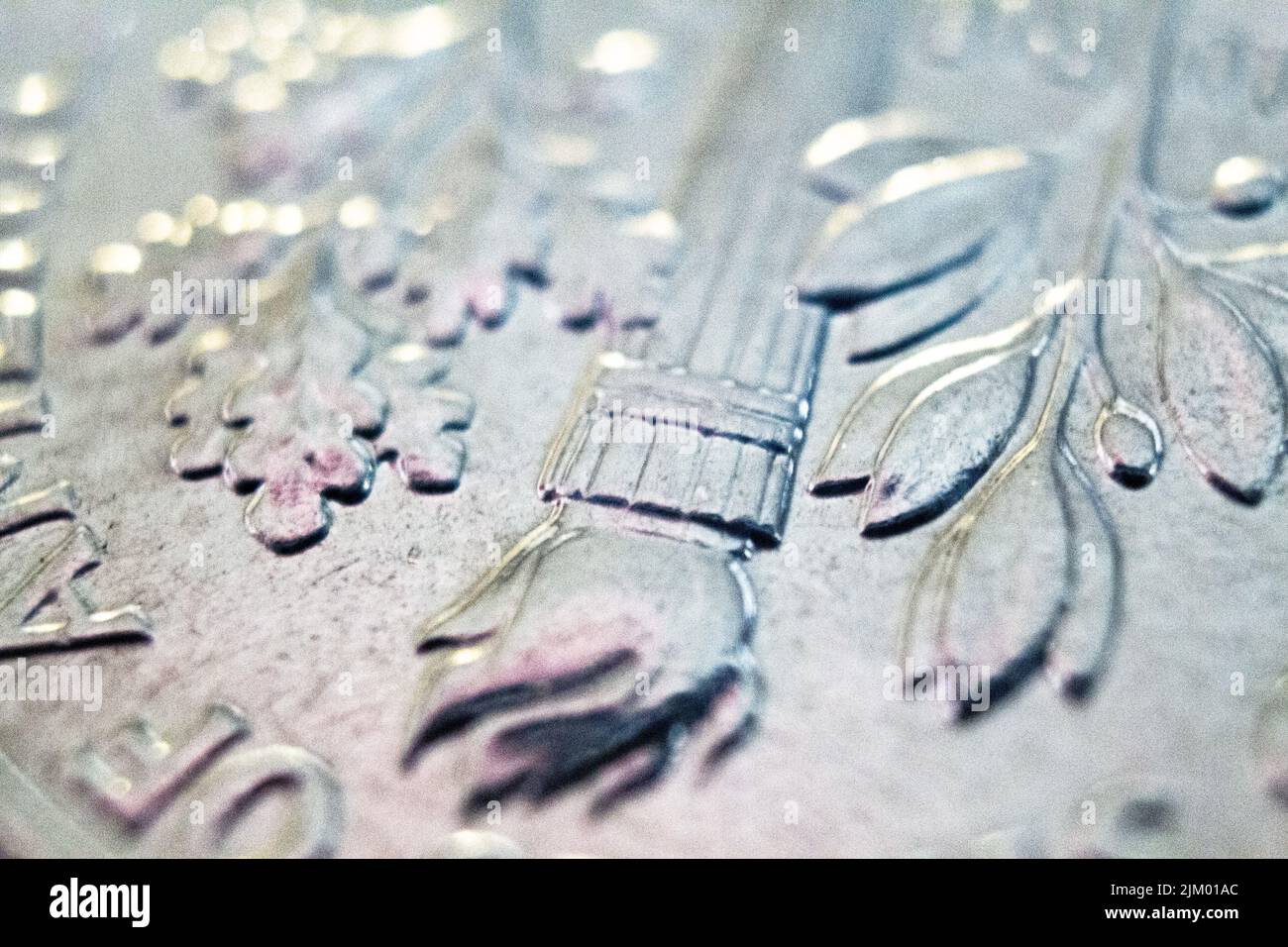 A macro shot of design of Torch on the dime coin Stock Photo - Alamy