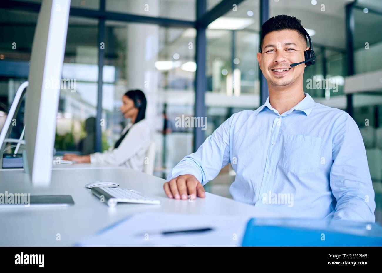 Our lines are open and wed love to help. a young man using a headset ...