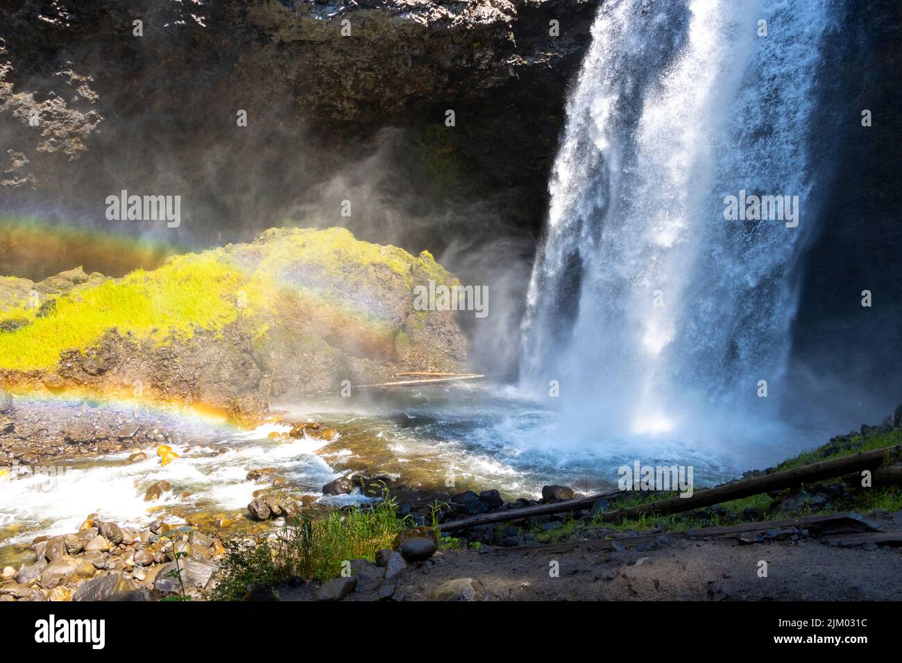 cascading waterfall deep in forest with rainbow at bottom Stock Photo ...