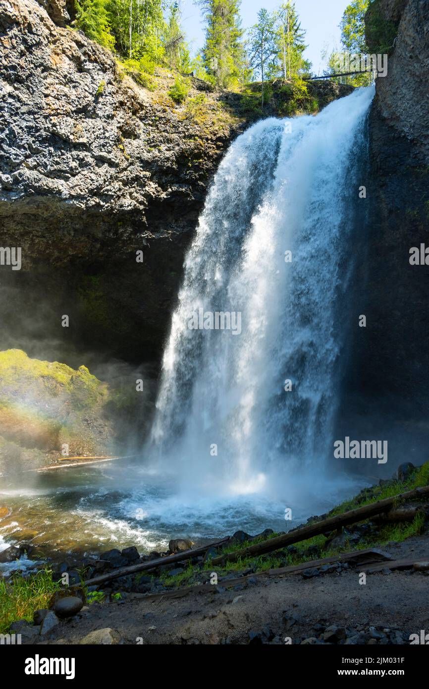 cascading waterfall deep in forest with rainbow at bottom Stock Photo ...