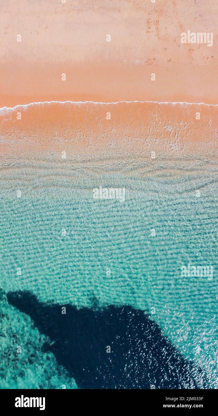 A beautiful aerial top view of sea waves washing the shore Stock Photo ...