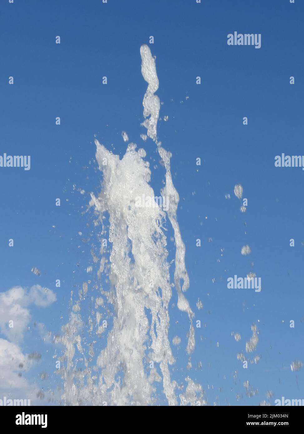 Water spraying from a fountain against the blue sky Stock Photo - Alamy