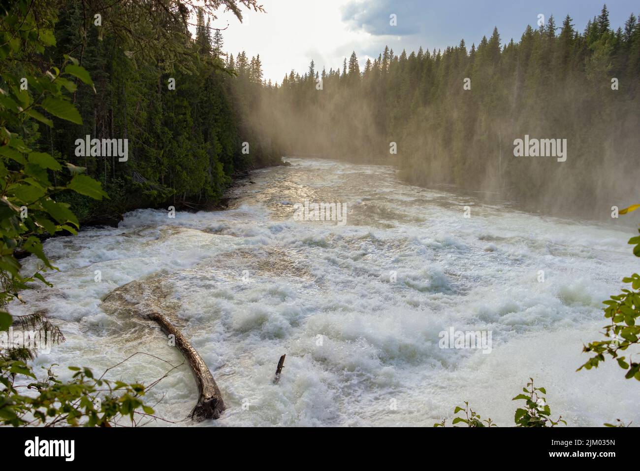downstream from waterfall, rapidly moving water with steam riving from ...