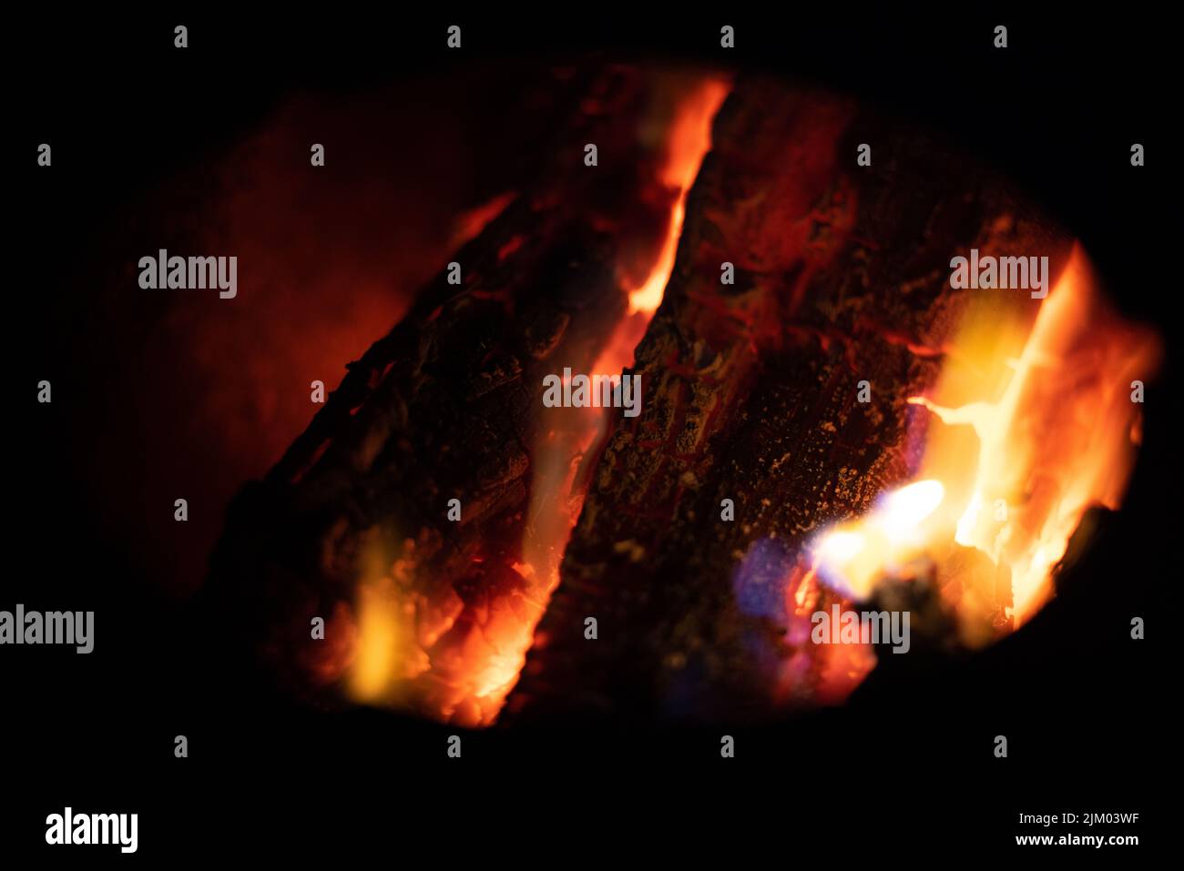 A closeup of woods burning in fire flames in the dark Stock Photo - Alamy