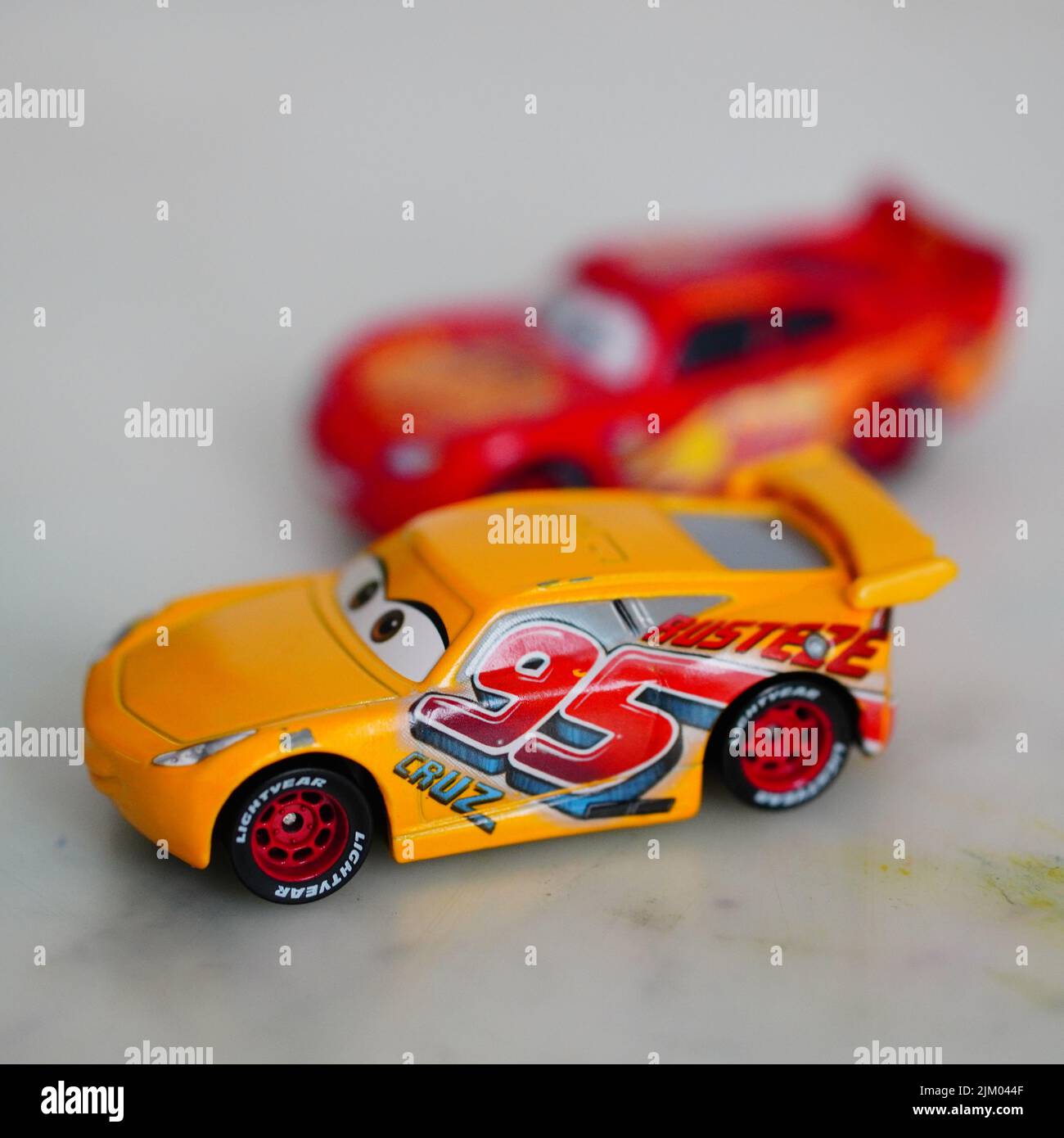 A selective focus shot of the Mattel Cruz Ramirez toy model race car ...